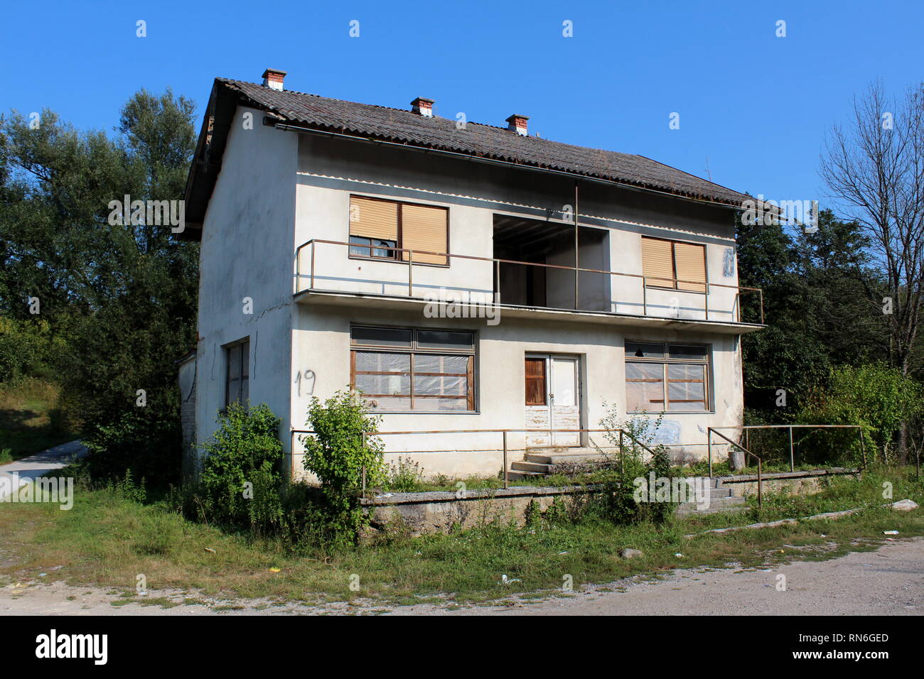 Abandoned family house with destroyed partially boarded windows and ...