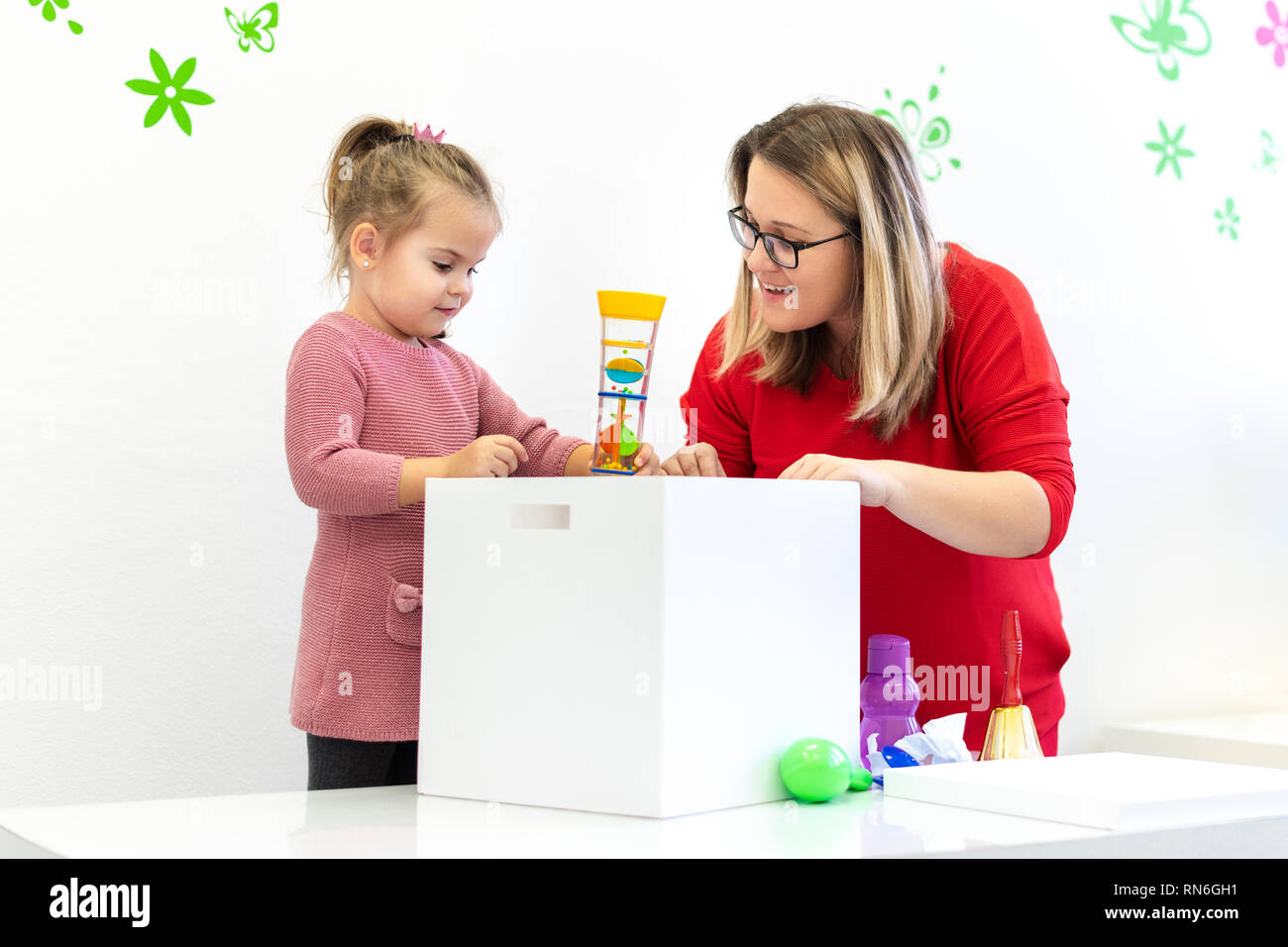Toddler girl in child occupational therapy session doing sensory ...