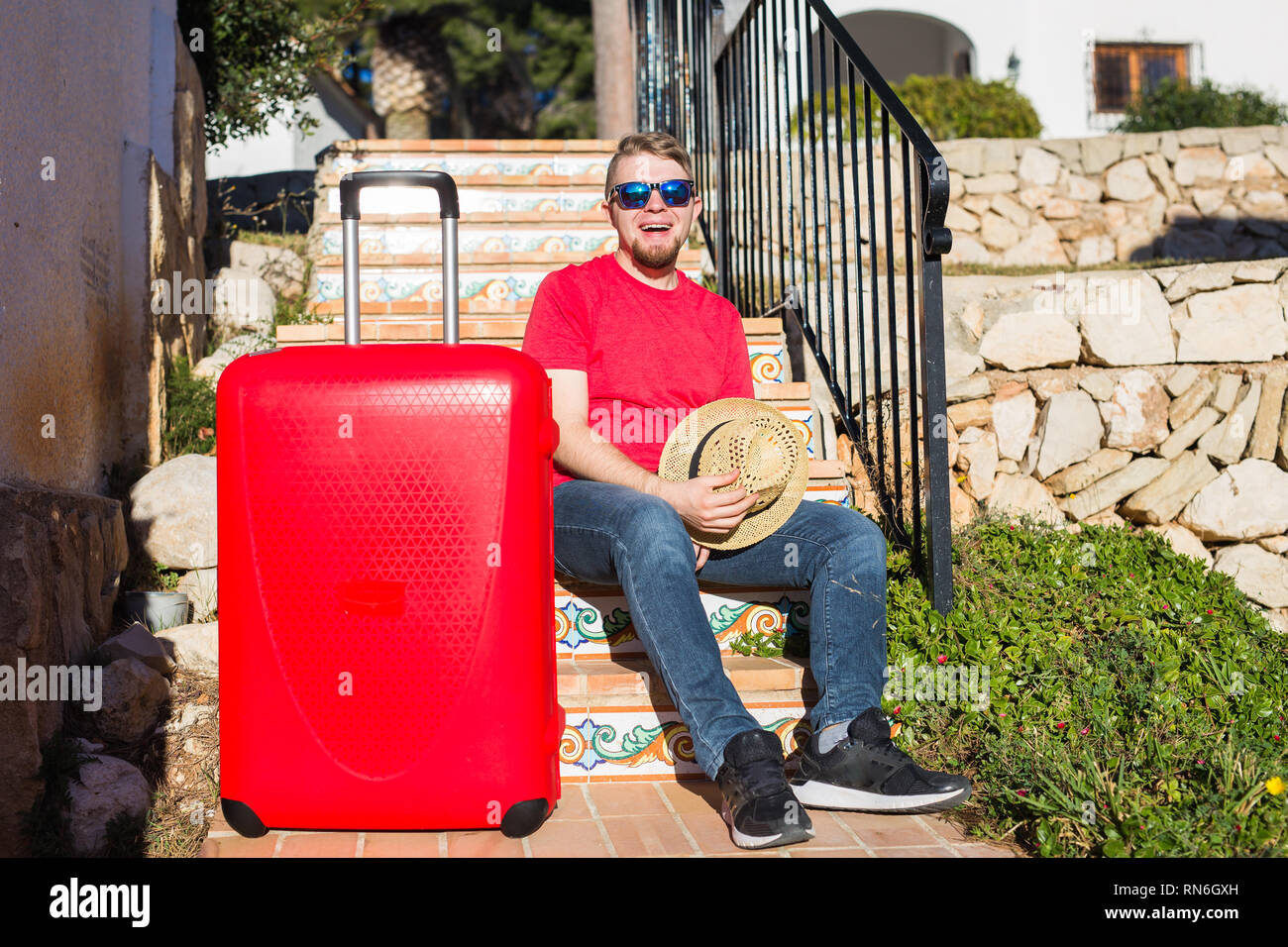 People, holidays, travelling and rest concept - young man sitting on ...