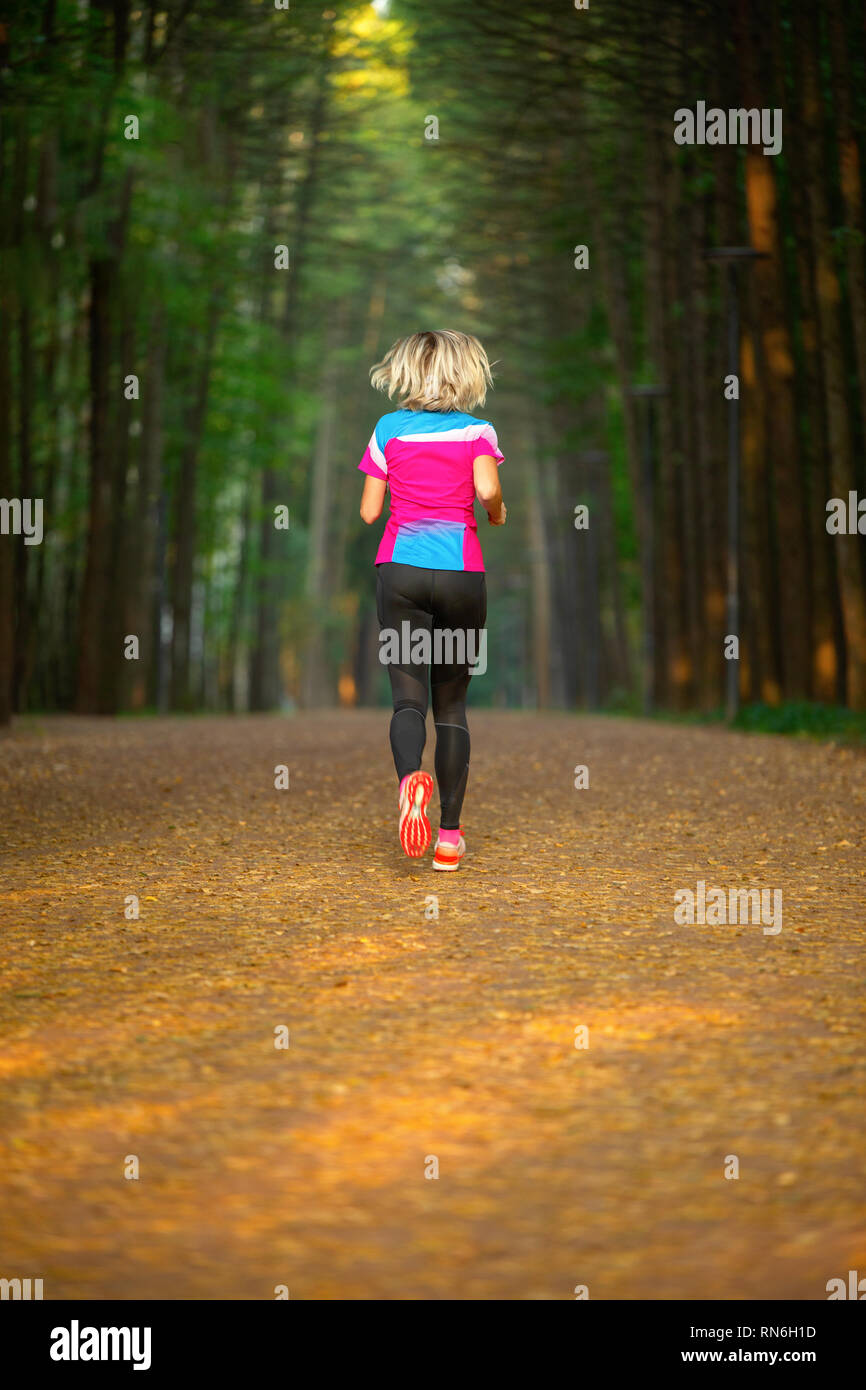 Young women running through park hi-res stock photography and images ...