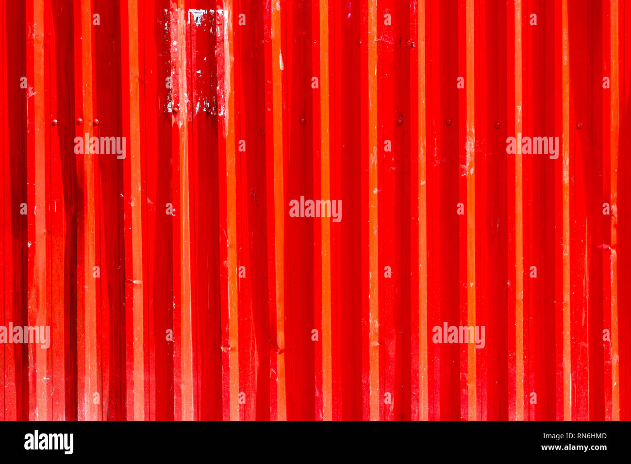 Corrugated iron plate used in construction works. Red color. Peeled ...