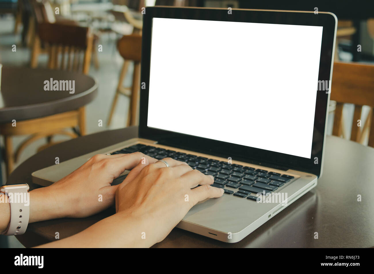 Woman's hands using computer laptop with blank screen on desk Stock ...