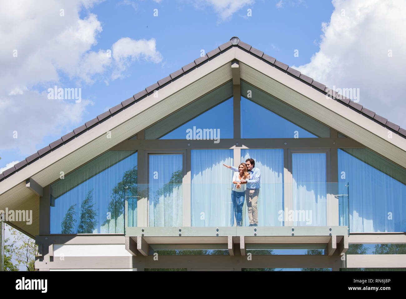 Family standing on balcony hi-res stock photography and images - Alamy