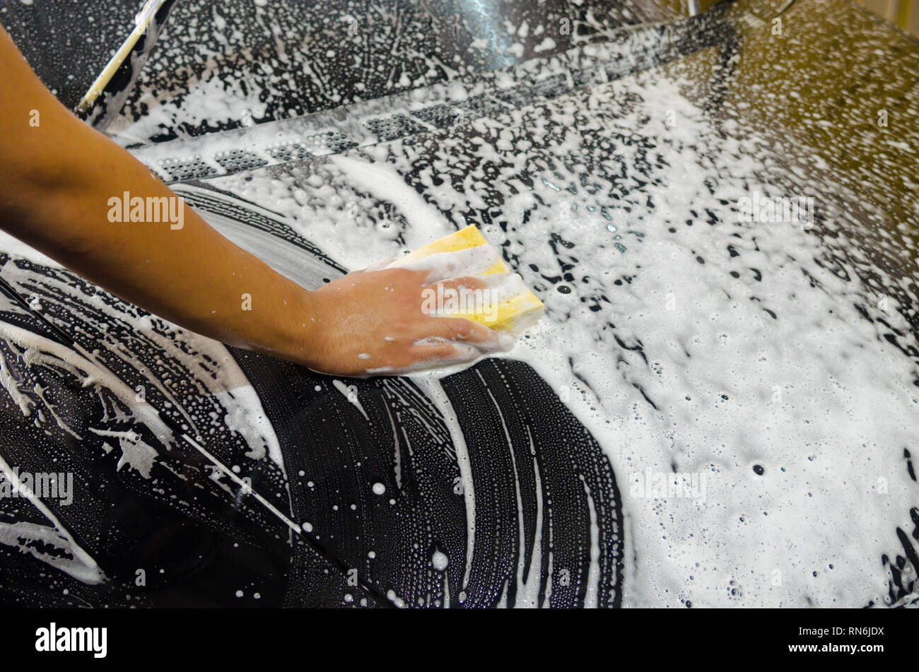Hand holding sponge washing car hi-res stock photography and images - Alamy