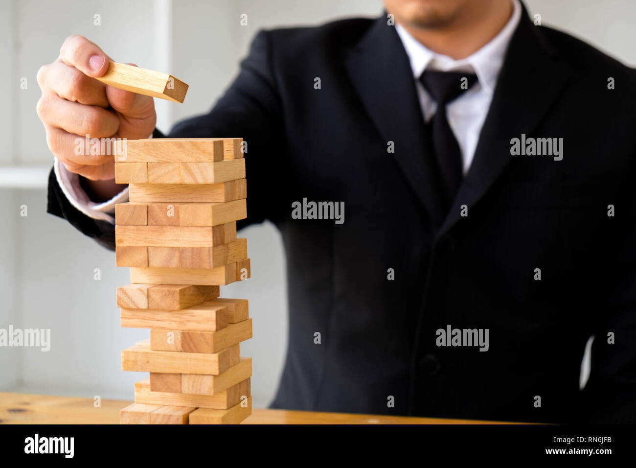 Businessmen picking domino blocks to fill the missing dominos. Growing ...