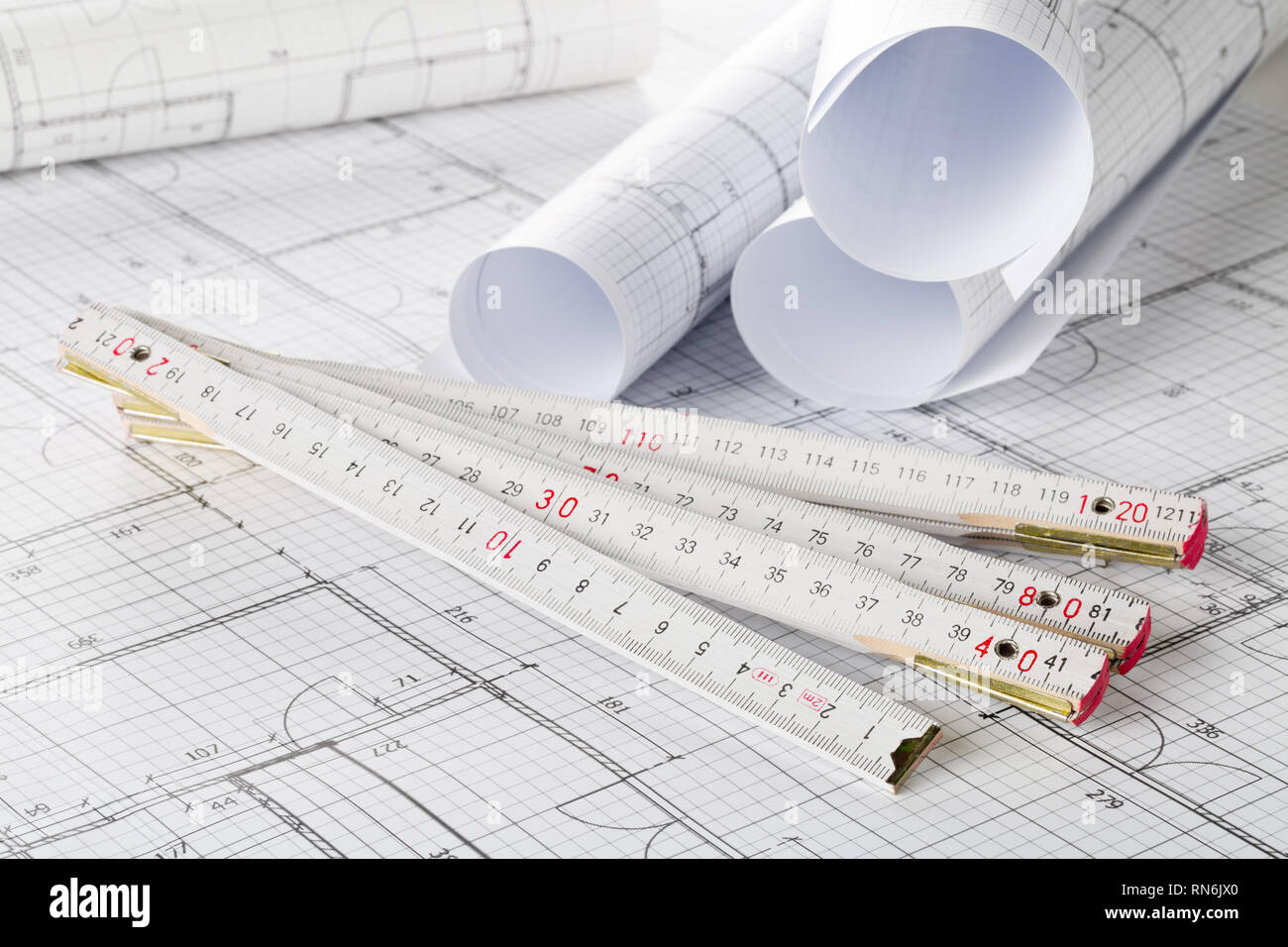 Rolls of architectural blueprint house building plans with folding rule ...