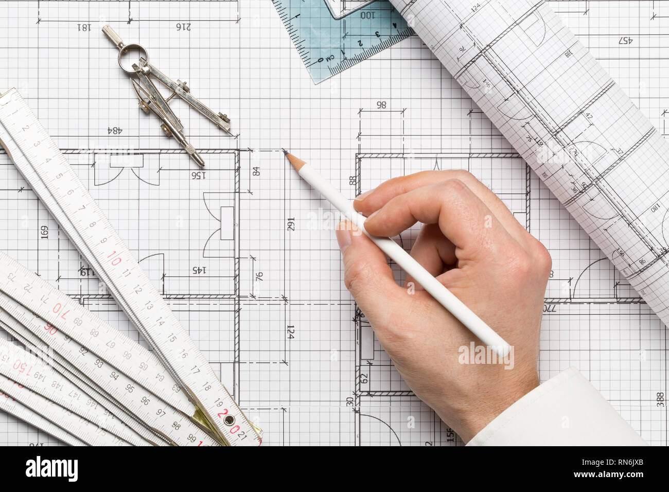 Architect pointing on architectural blueprint house building plan with ...