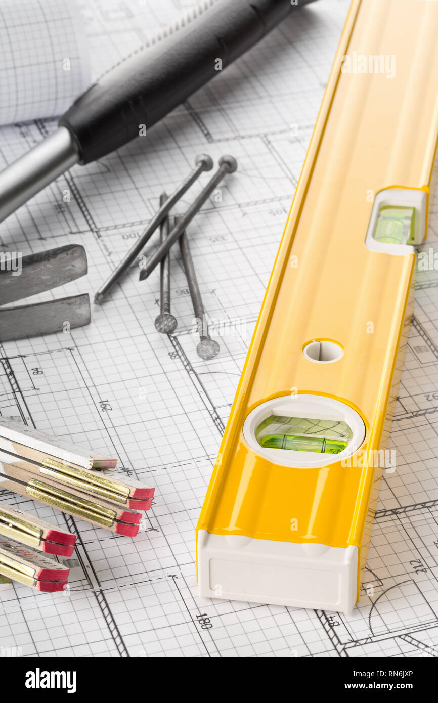 Construction tools with hammer, nails, folding rule and level on ...