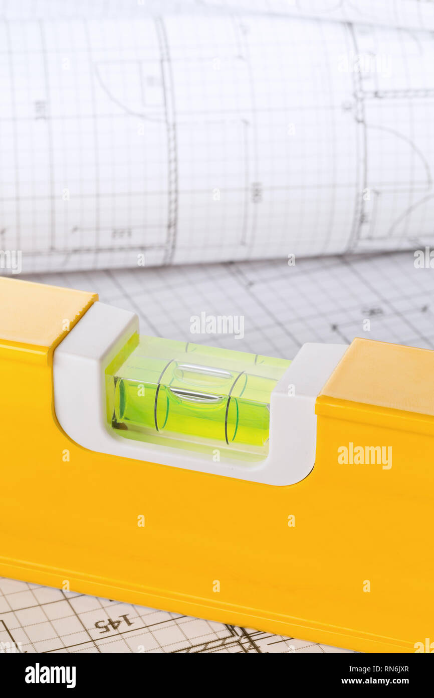 Orange construction level on architectural blueprint building plan ...