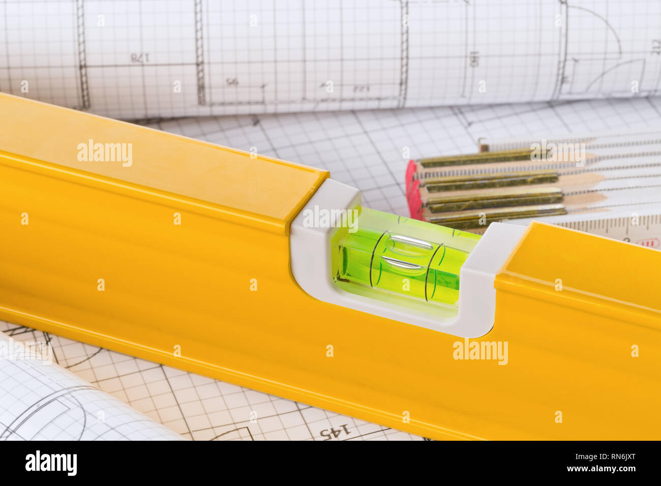 Orange construction level on architectural blueprint building plan ...