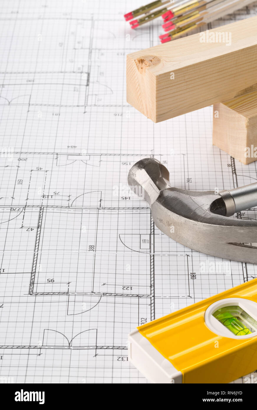 Construction tools and wooden strips on architectural blueprint house ...