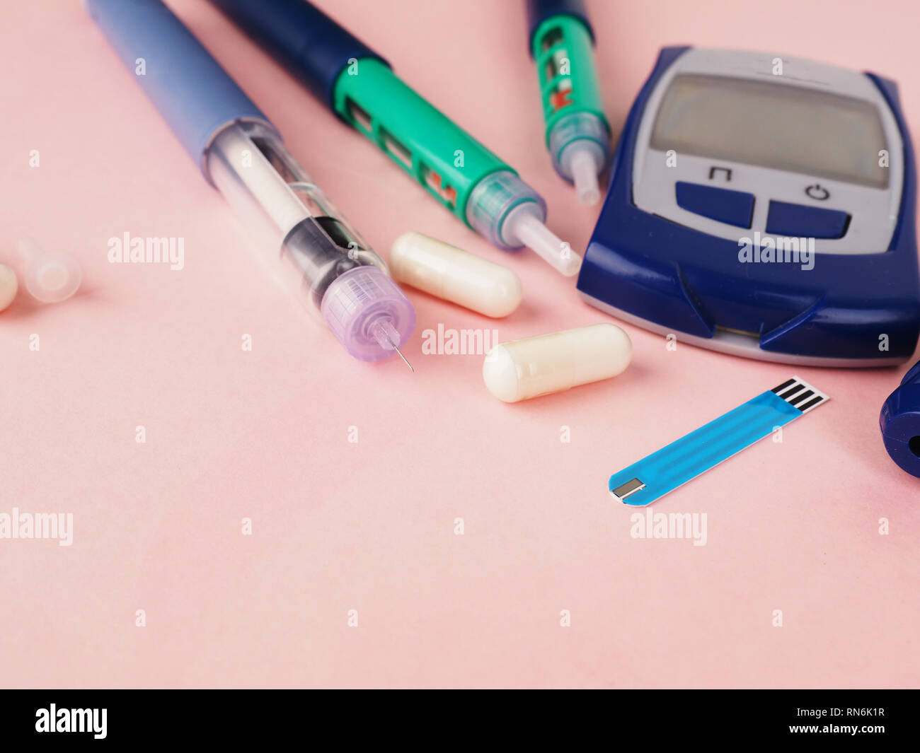 diabetes pen injection needle, syringes lie on pink background ...