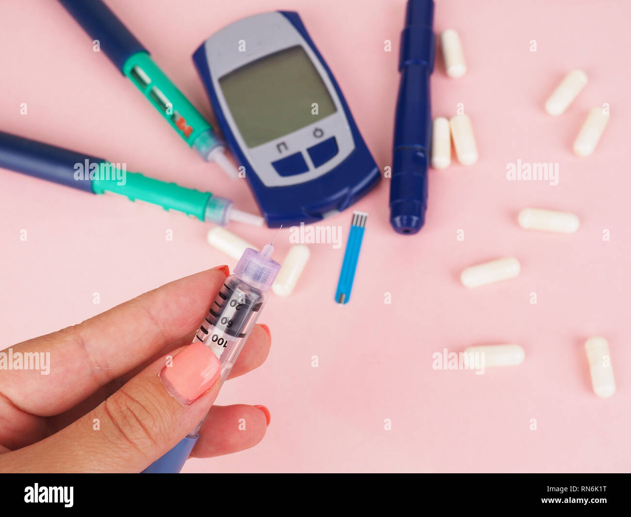 diabetes pen injection needle, syringes lie on pink background ...