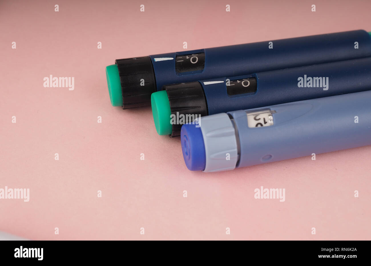 diabetes pen injection needle, syringes lie on pink background ...