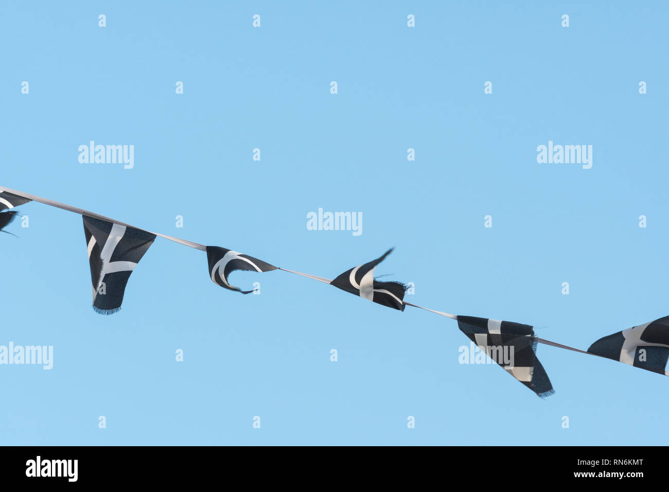 String of St. Piran's Cornwall / Cornish flags fluttering in the breeze ...