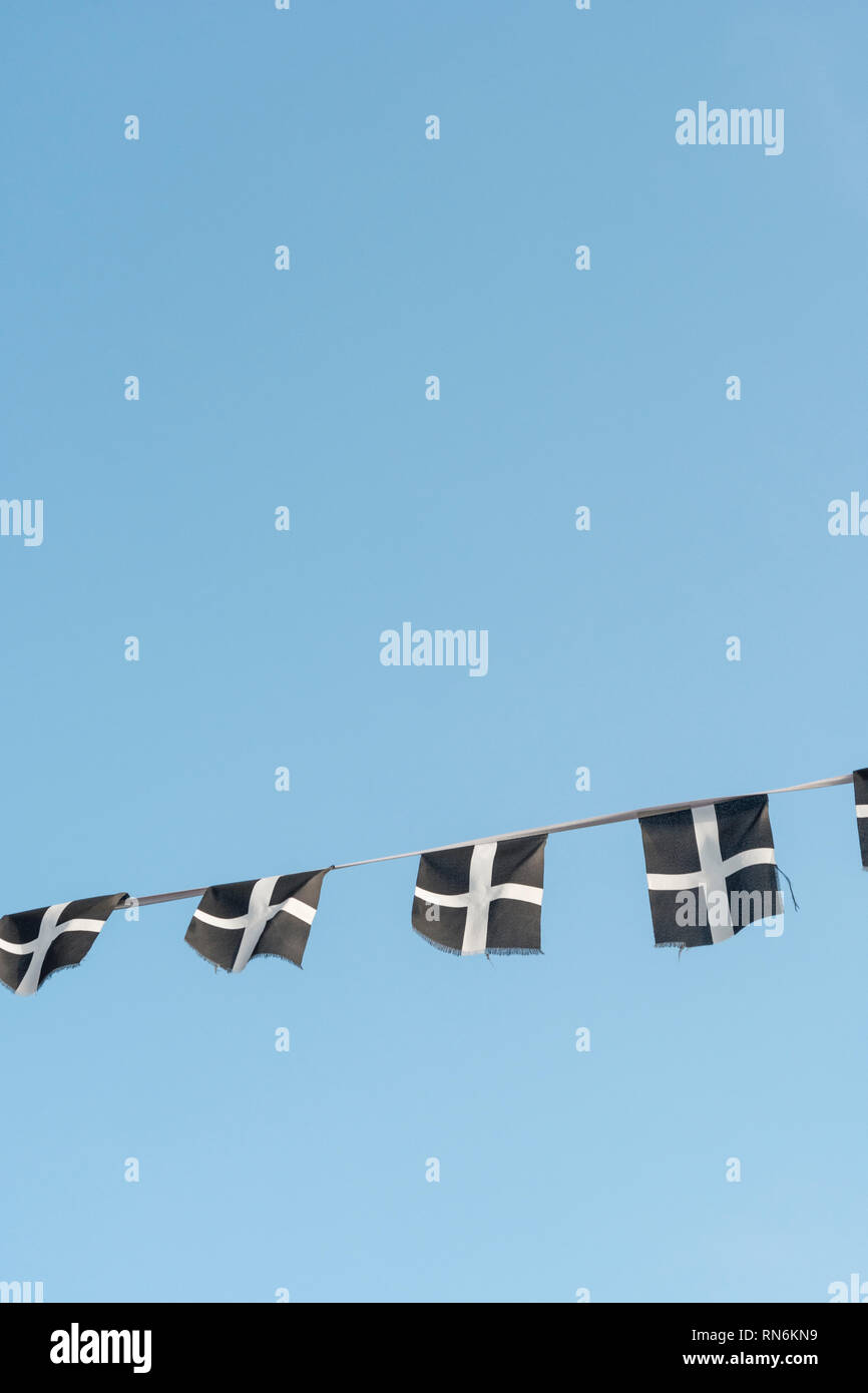 String of St. Piran's Cornwall / Cornish flags fluttering in the breeze ...