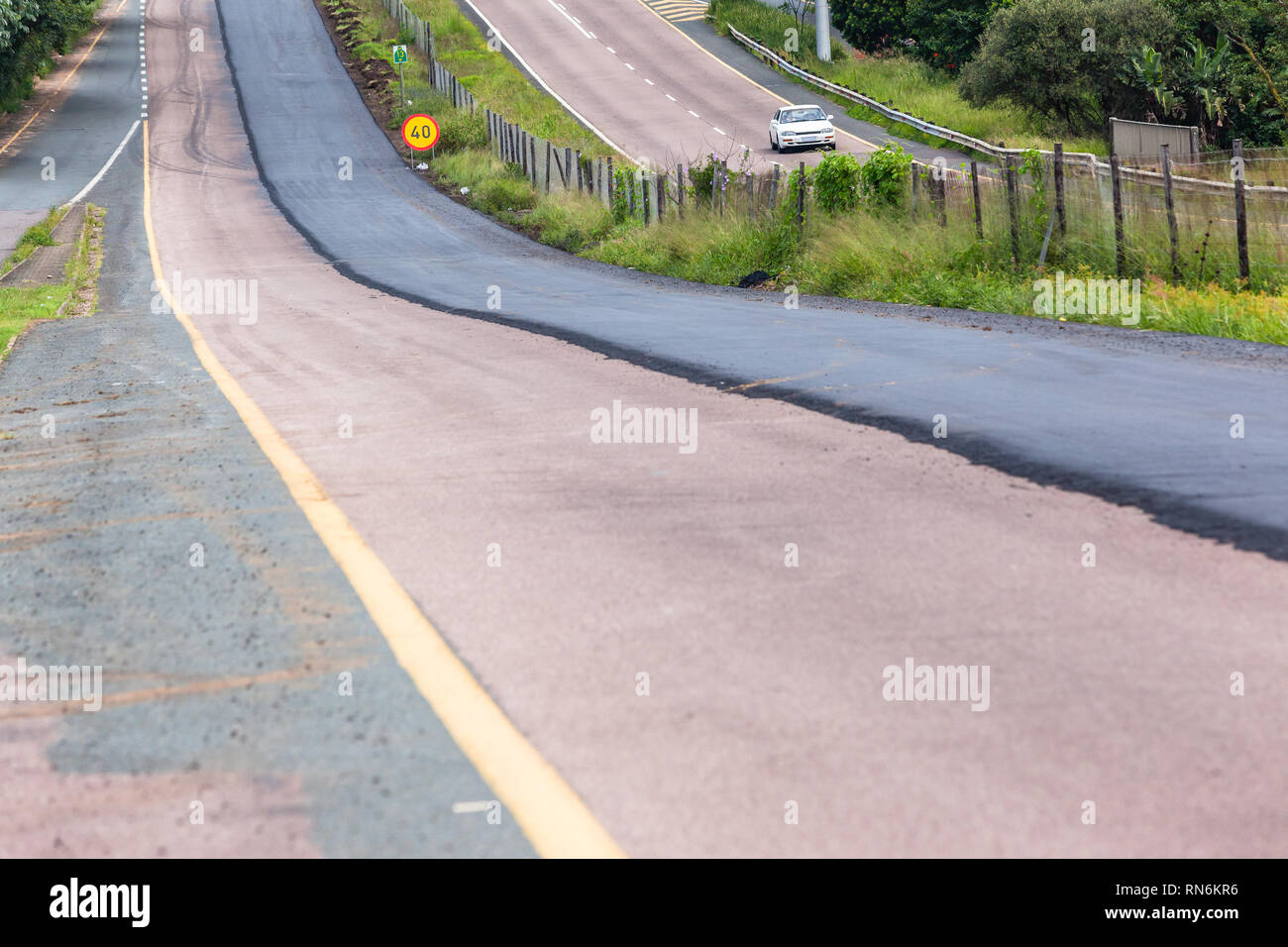 Road highway dual lanes with one lane resurfaced with new asphalt tar ...