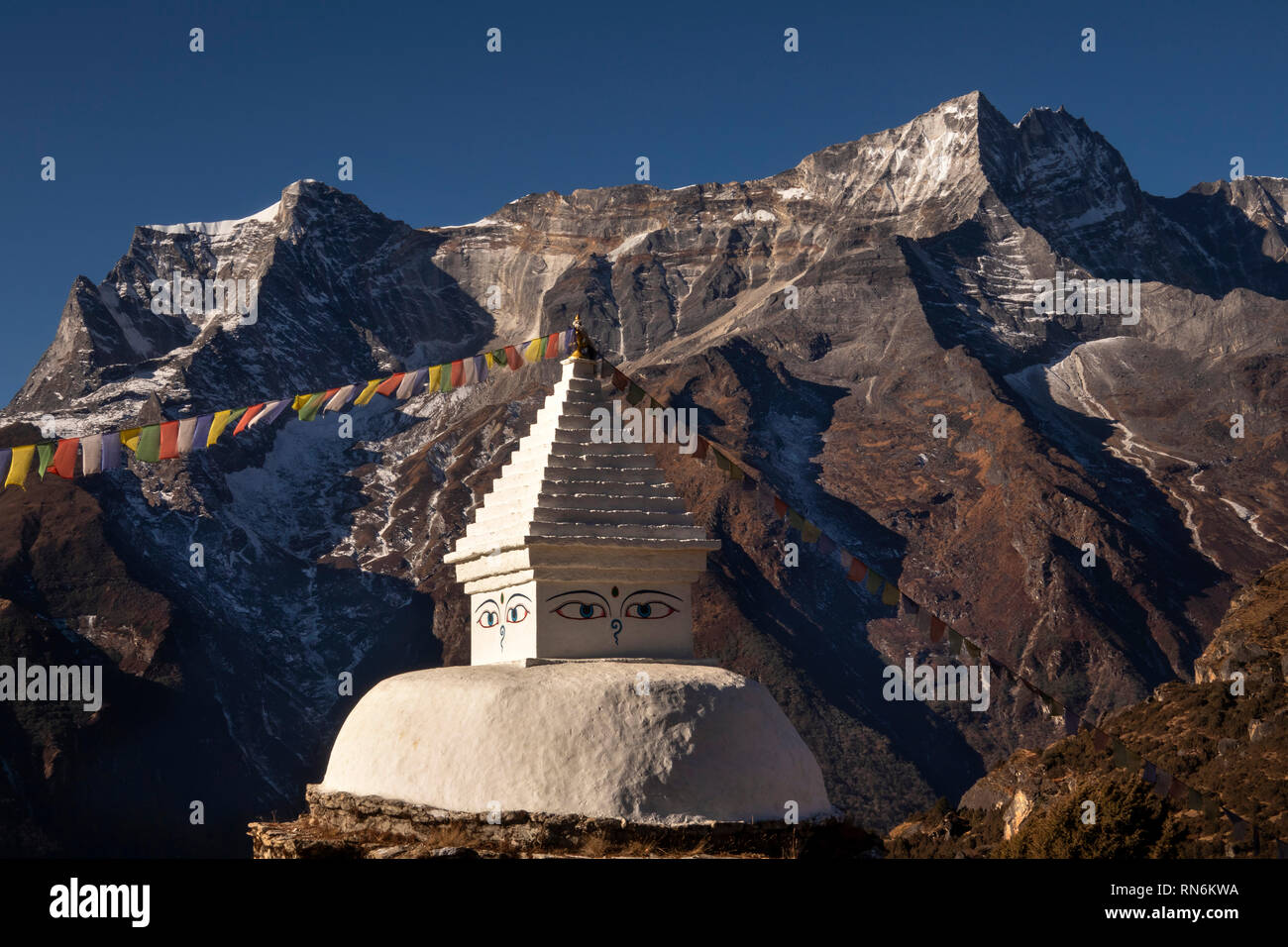Nepal, Namche Bazaar, elevated white painted chorten with all seeing ...