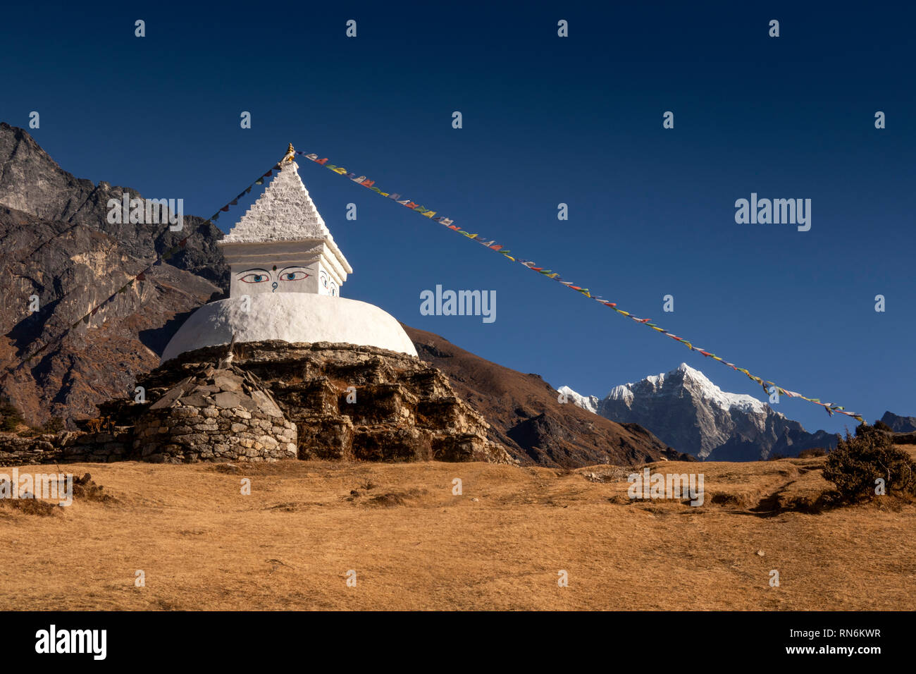 Nepal, Namche Bazaar, elevated white painted chorten with all seeing ...