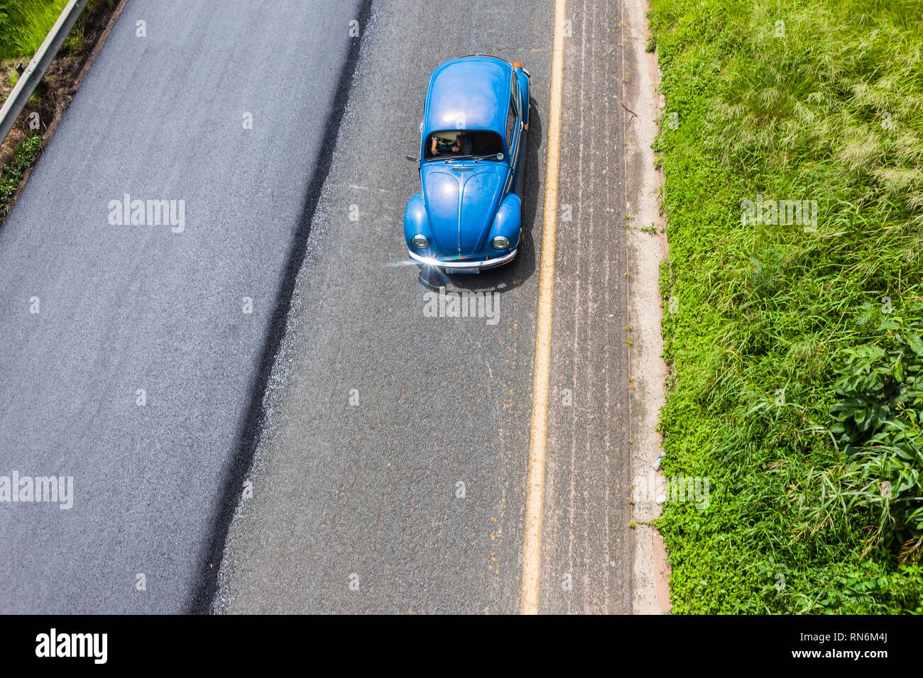Blue vintage VW vehicle on road highway dual lanes with one lane ...