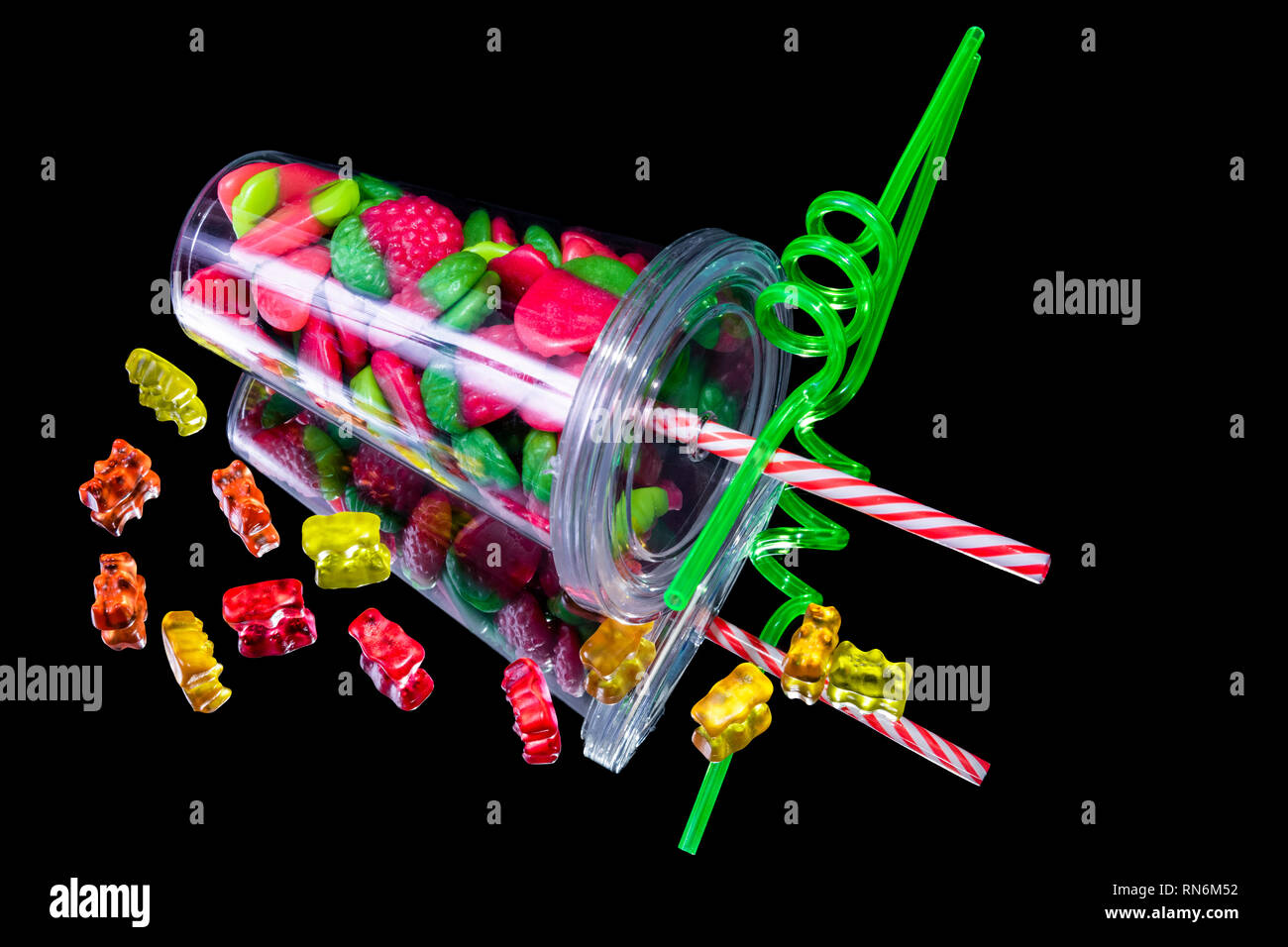 strawberry candies in a glass shake with straws and gummy bears on a ...