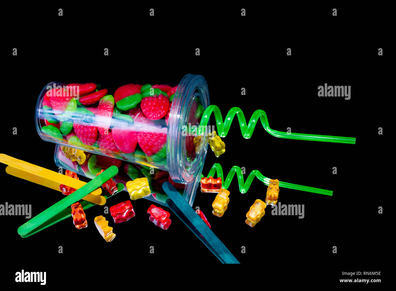 strawberry candies in a glass shake with straws and gummy bears on a ...