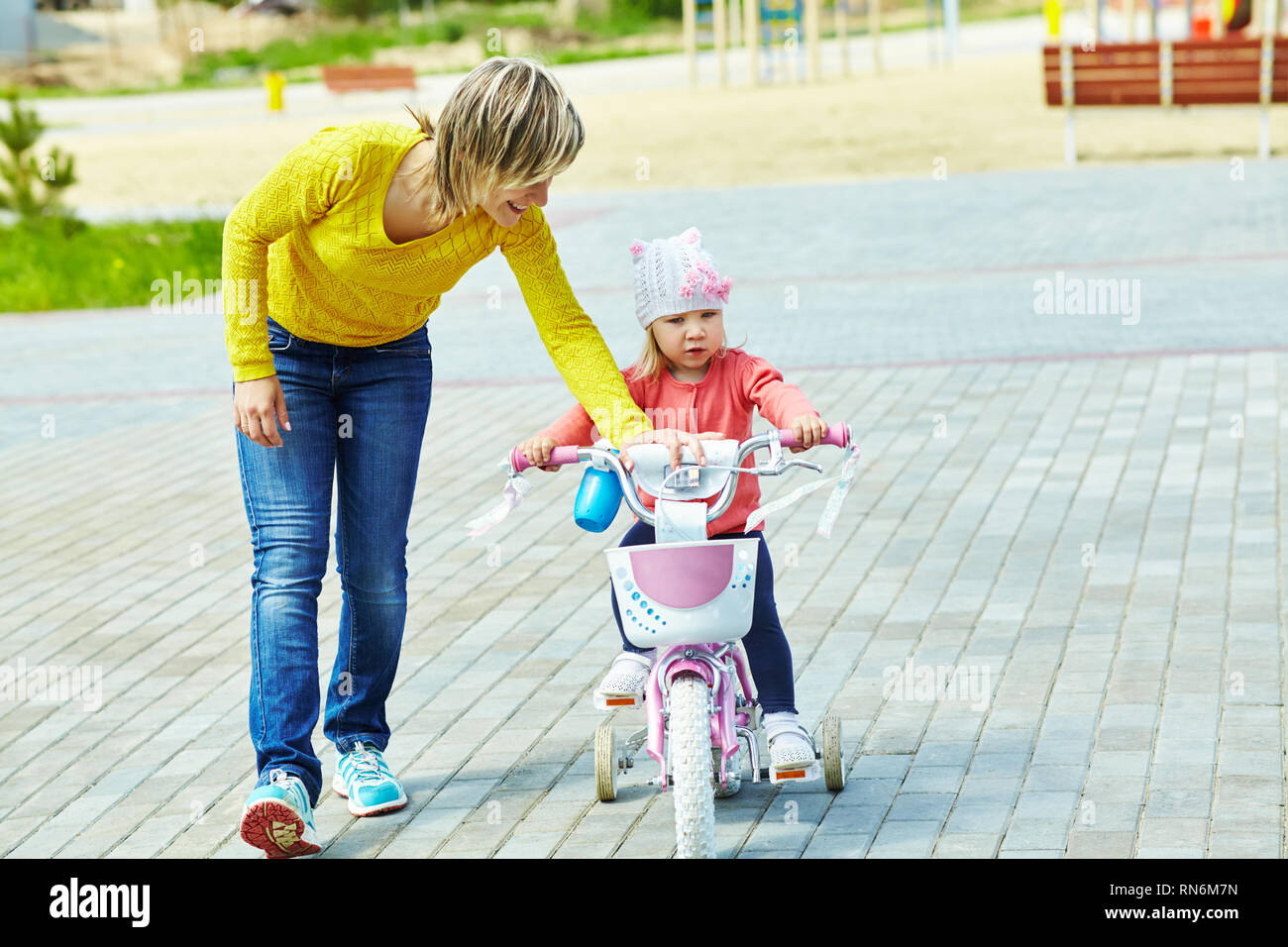 little girl with mother riding a bicycle. child outdoor Stock Photo - Alamy
