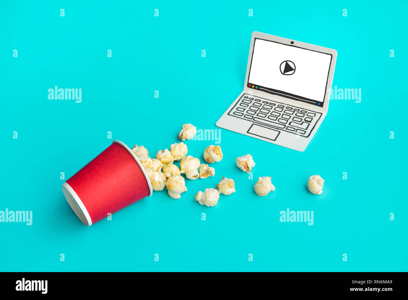 Pop corn with paper art laptop on pastel color background.Food and ...