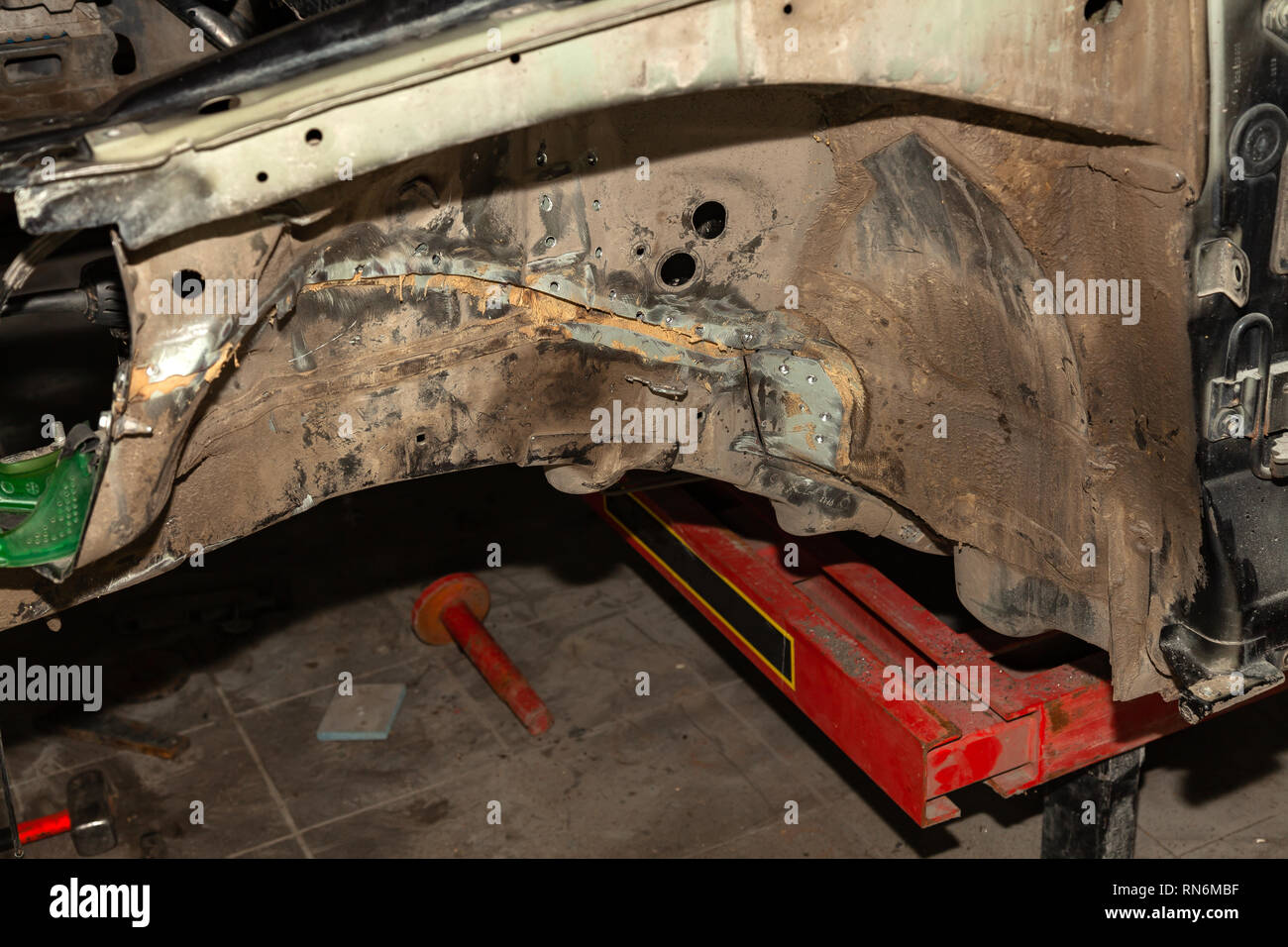 Close-up of two car body parts connected by spot welding after an ...
