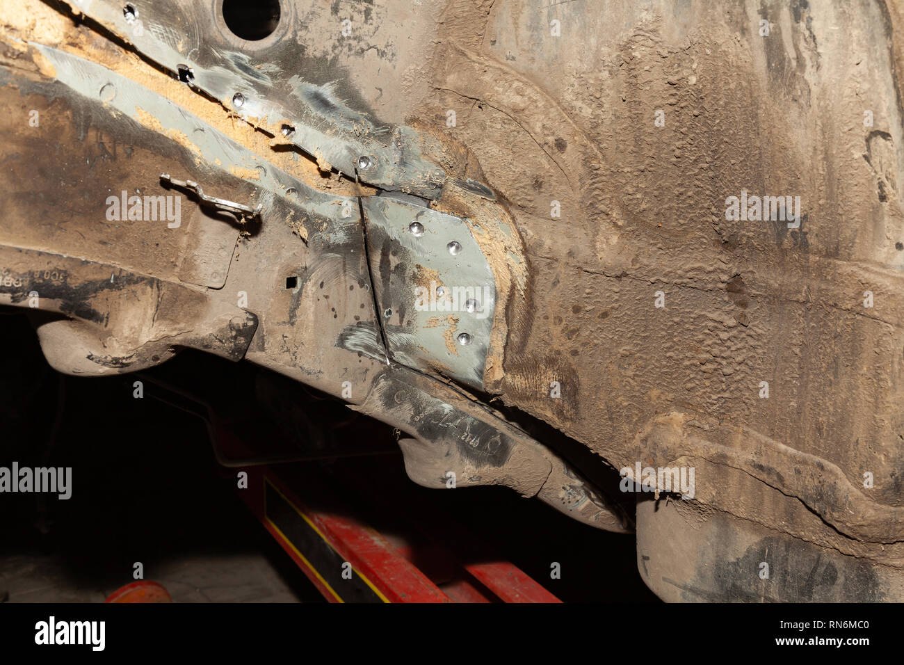 Close-up of two car body parts connected by spot welding after an ...