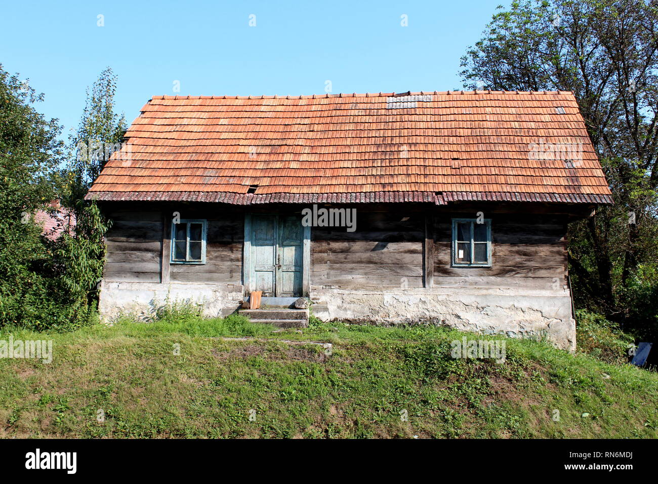 Small abandoned old wooden family house with dilapidated boards and ...
