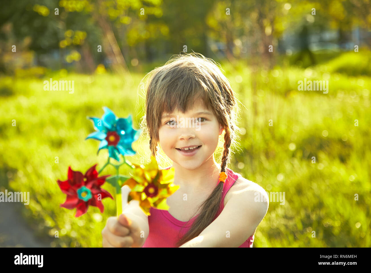Girl with a pinwheel hi-res stock photography and images - Alamy