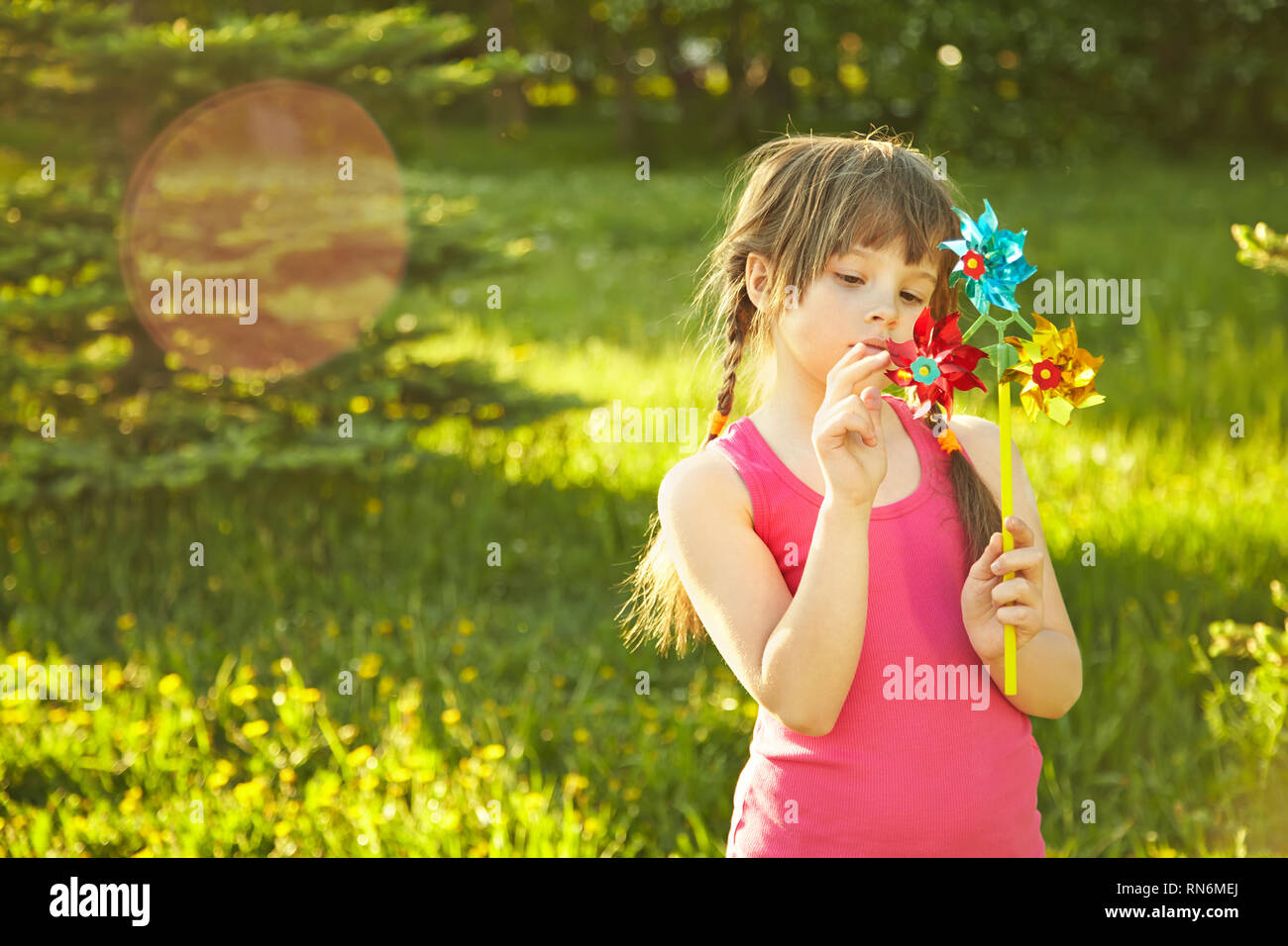 Girl with a pinwheel hi-res stock photography and images - Alamy