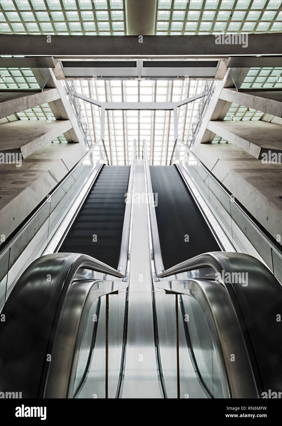 Vertical escalators at Liege-Guillemins railway station in an abstract ...