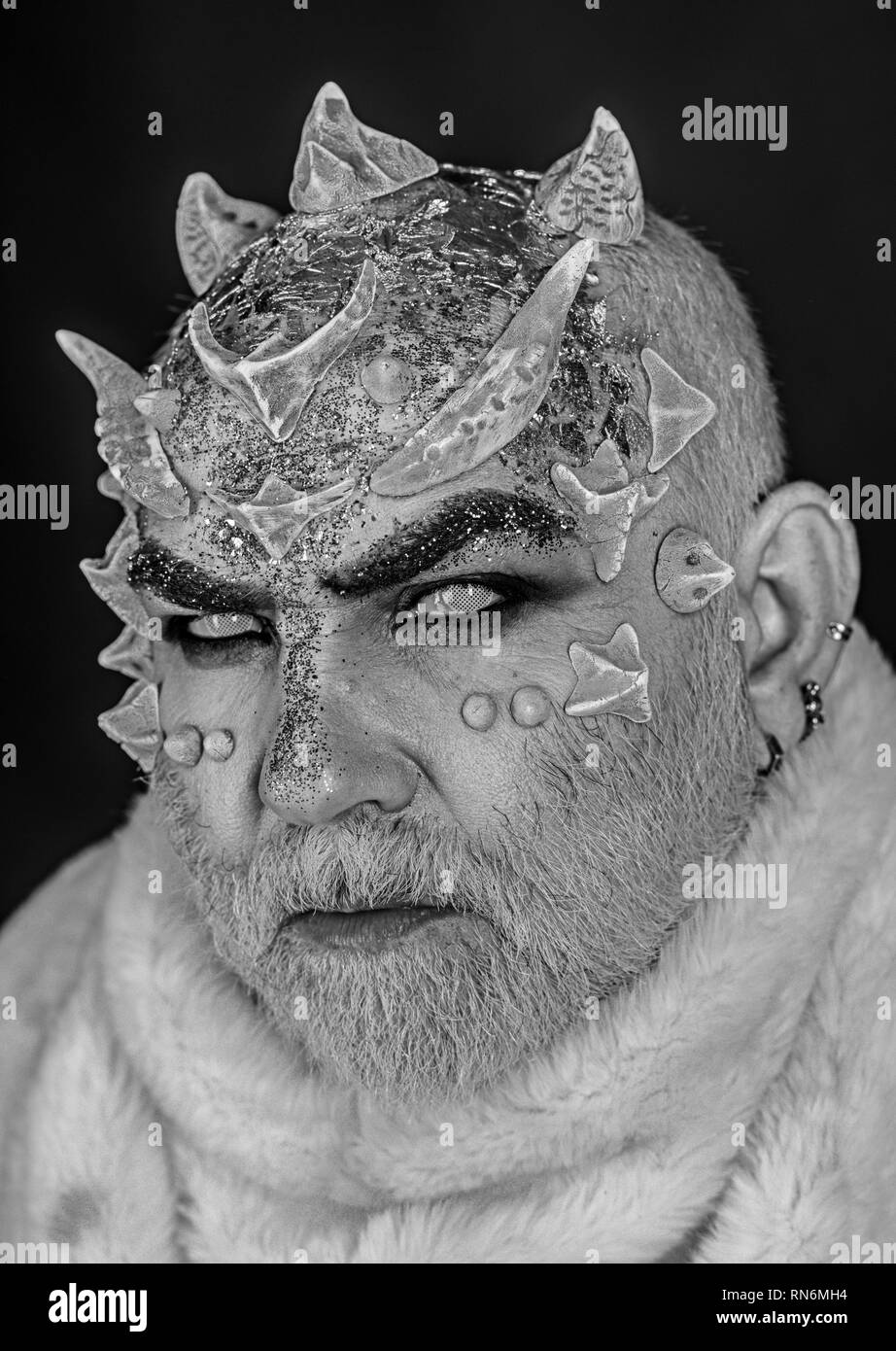 Alien, demon, sorcerer makeup. Demon on black background, close up ...