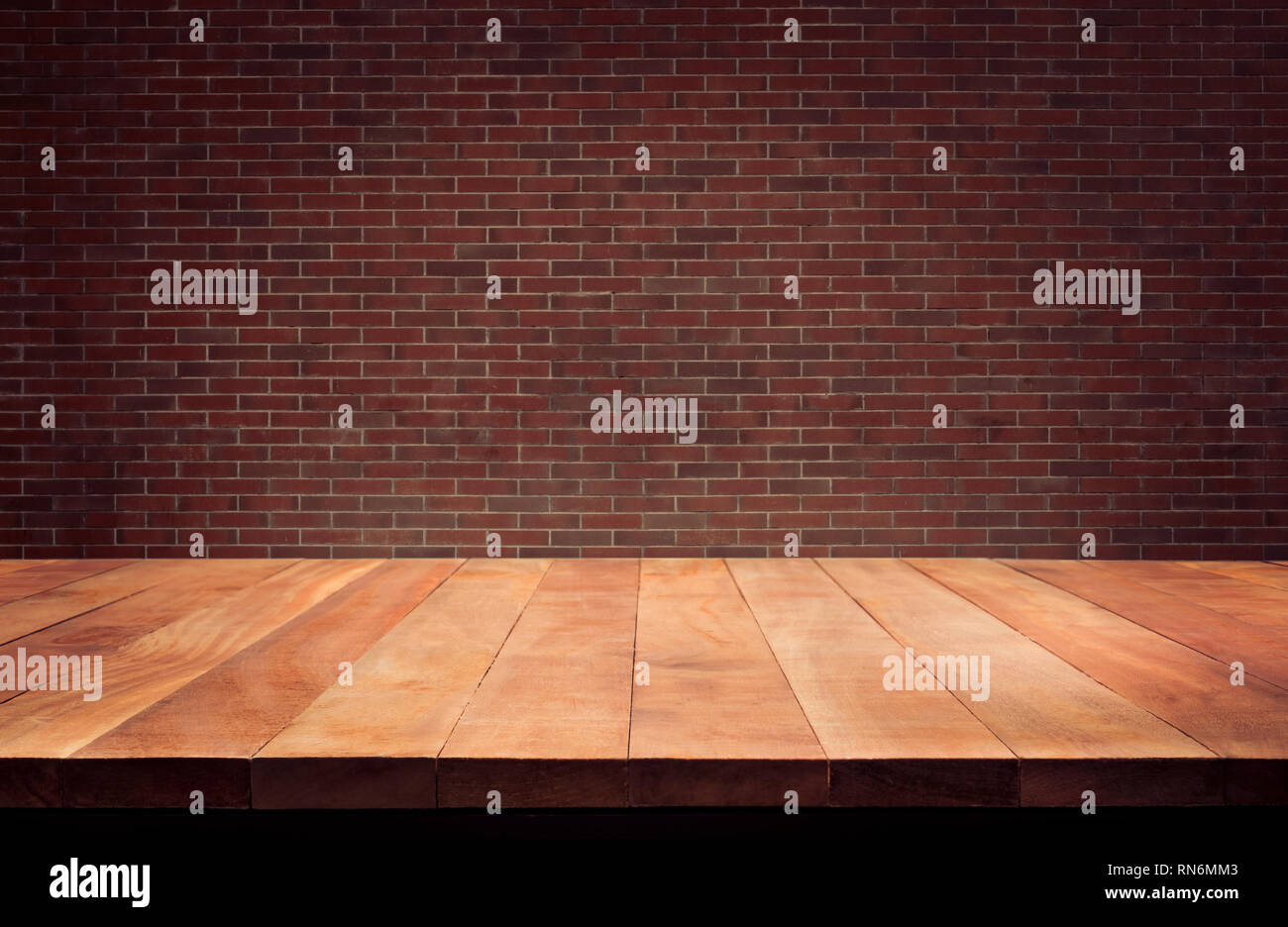 Empty wood table top with Brown brick wall background.For create ...