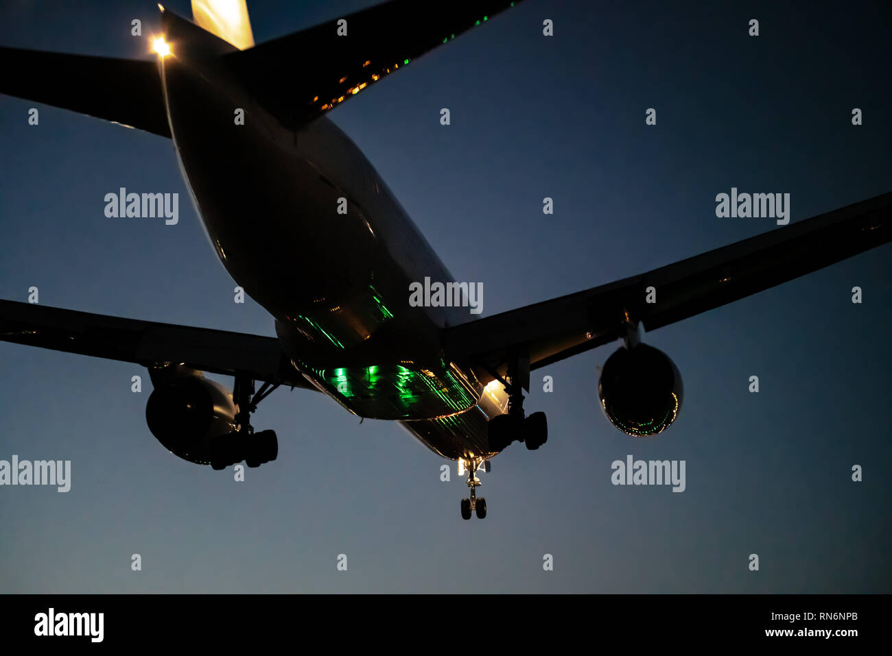 Jet plane landing scene at dusk Stock Photo - Alamy