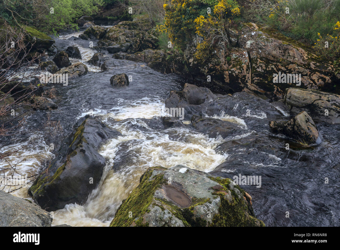 Fast running river and boulders near Adara, County Donegal, Ireland ...
