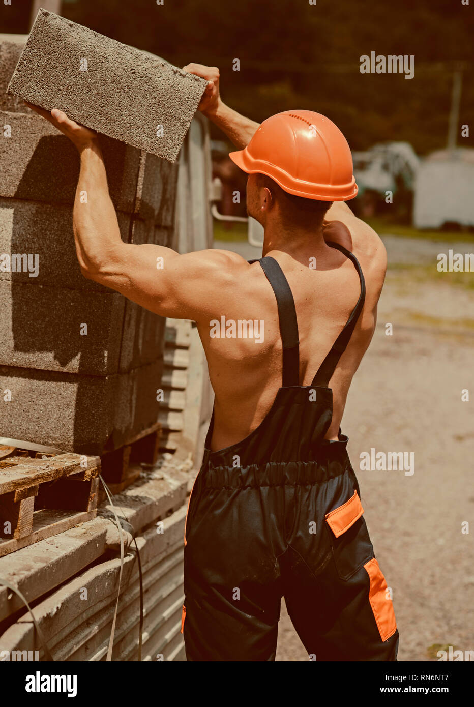 Construction concept. Man carry bricks for construction works. Builder ...