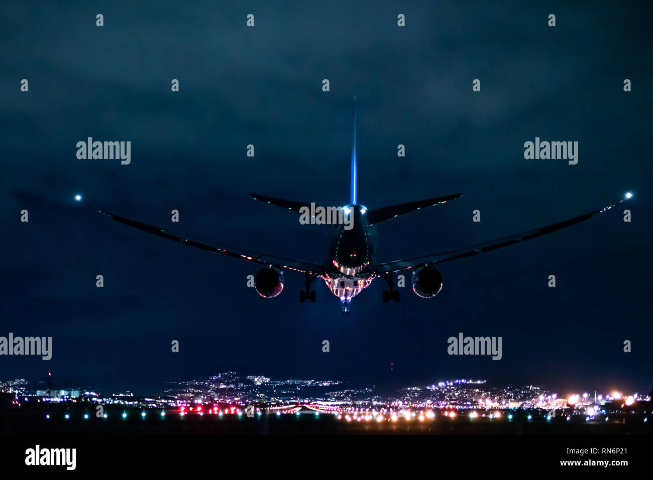 Jet plane landing scene in the night Stock Photo - Alamy