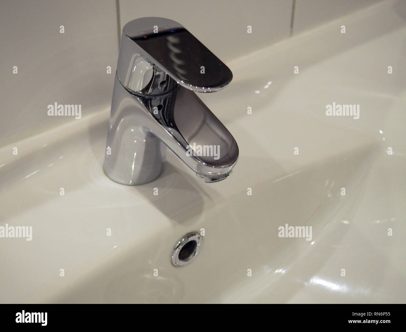faucet flowing water in the bathroom, sink with tap Stock Photo - Alamy