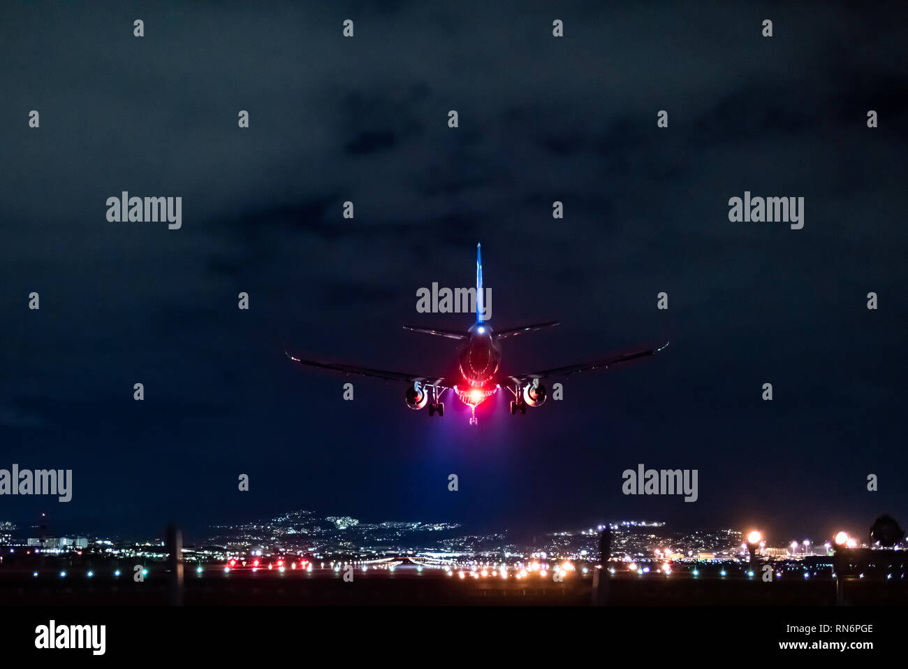 Jet plane landing scene in the night Stock Photo - Alamy