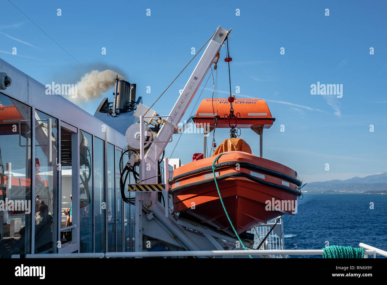Red rescue boat Lifeboat stands on deck of a ferry cruiser Stock Photo ...