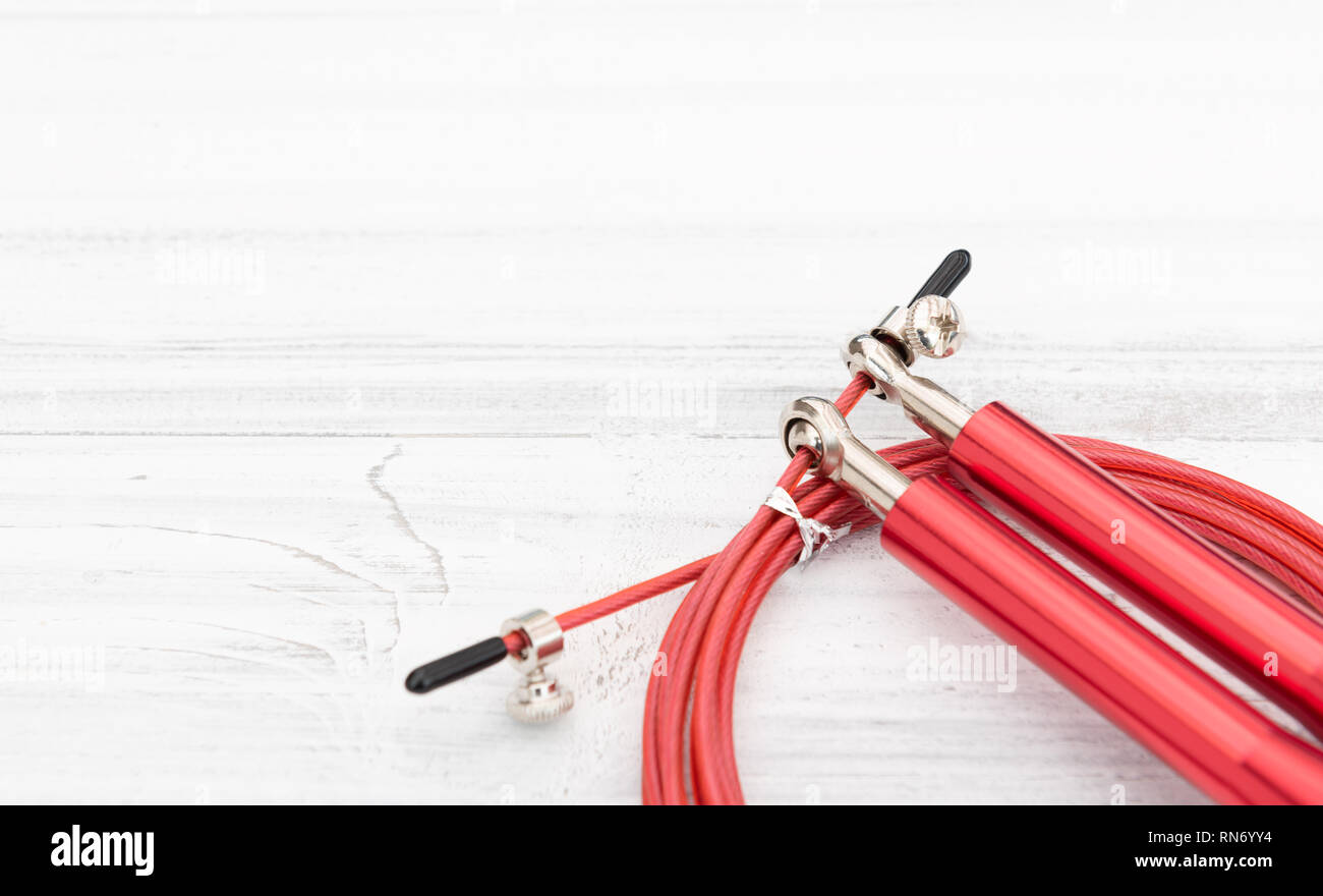 Modern red jump rope on white wooden background,flat lay Stock Photo ...