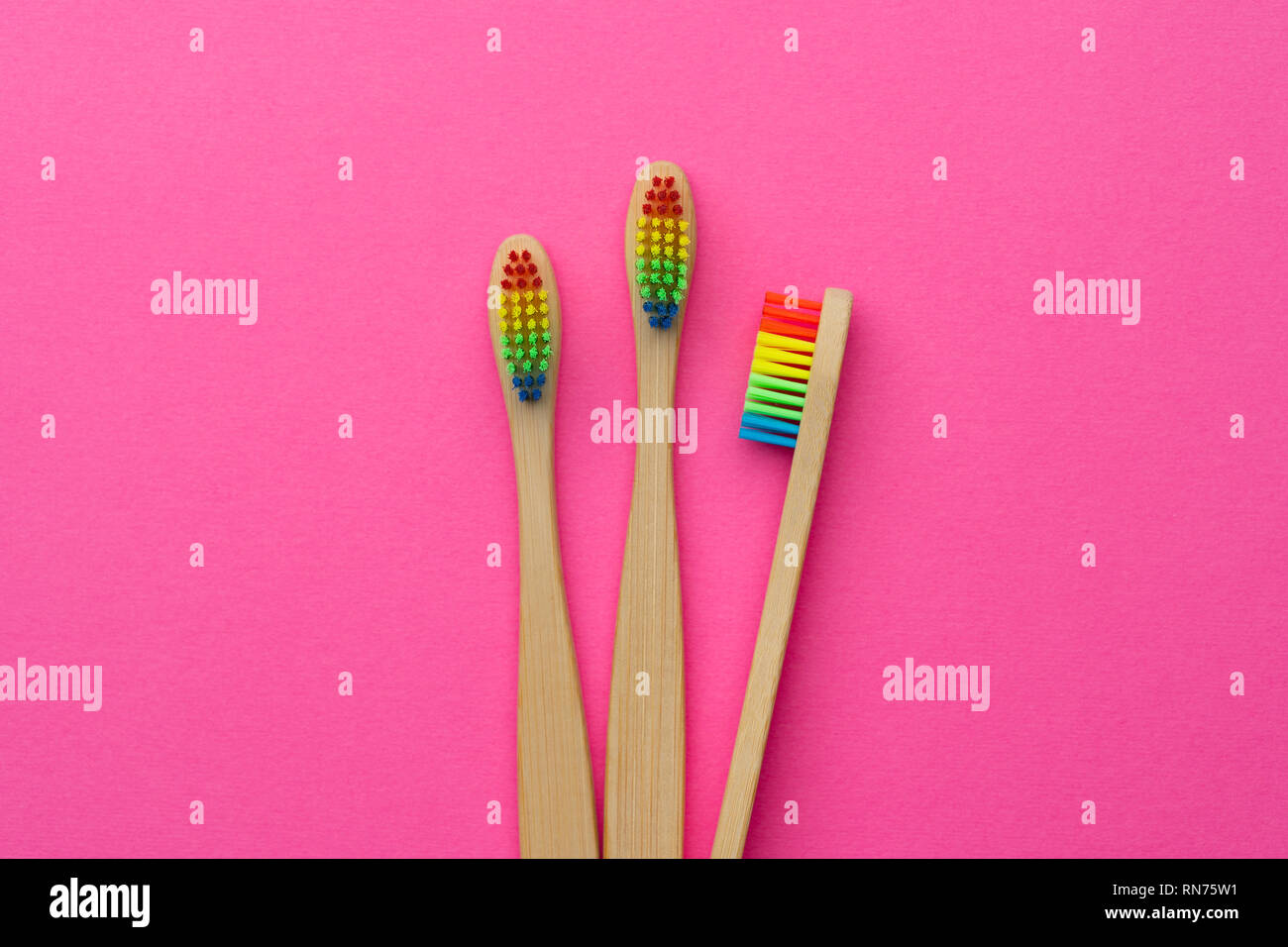 Image of three toothbrushes with rainbow-colored bristles Stock Photo ...