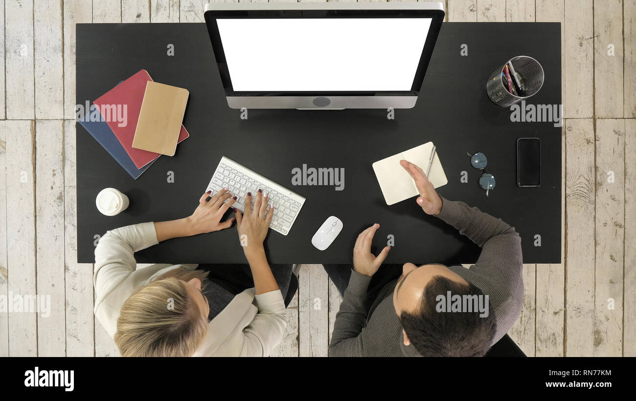 Two managers working discussing project on the screen of computer ...