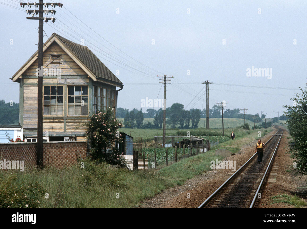 British Rail worker inspecting the railway tracks at Worstead old ...