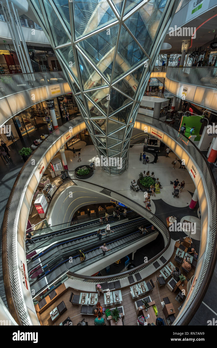 People walking inside Myzeil shopping mall. Futuristic architecture ...
