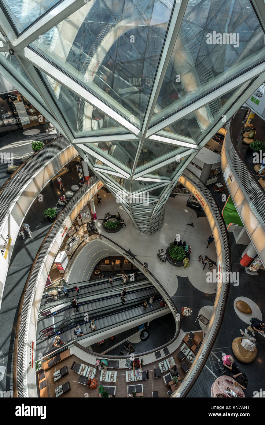 People walking inside Myzeil shopping mall. Futuristic architecture ...