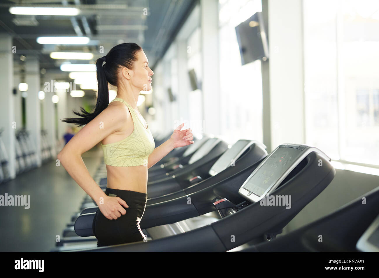 Girl on treadmill Stock Photo - Alamy